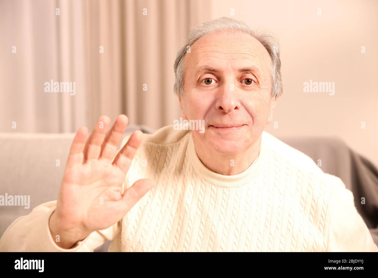 Handsome senior man waving hi-res stock photography and images - Alamy