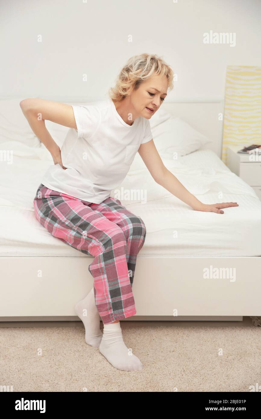 Woman backache home interior hi-res stock photography and images - Alamy