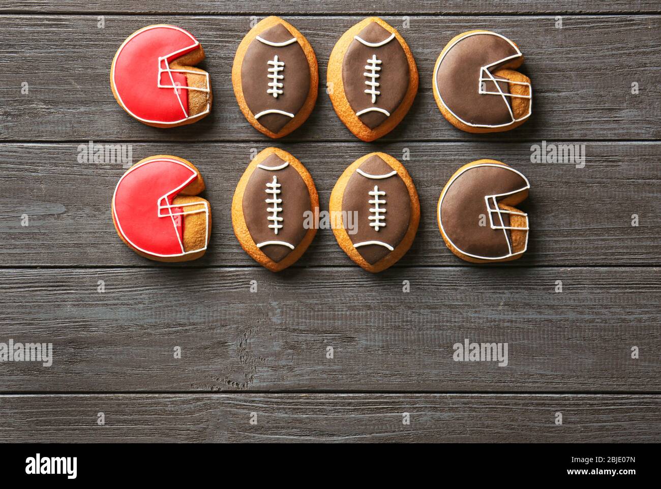 Tasty football cookies on wooden background Stock Photo - Alamy