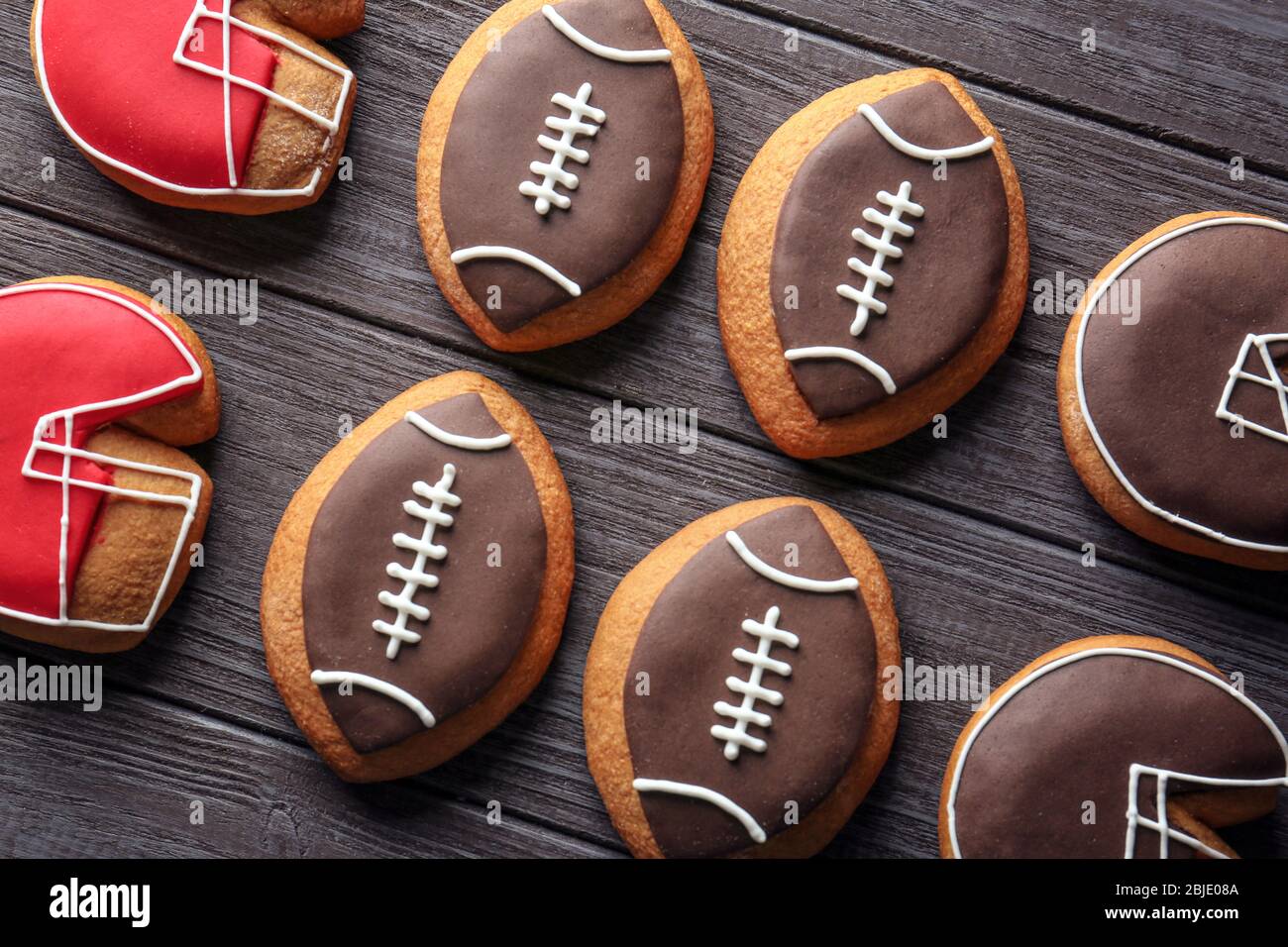 Tasty football cookies on wooden background Stock Photo - Alamy