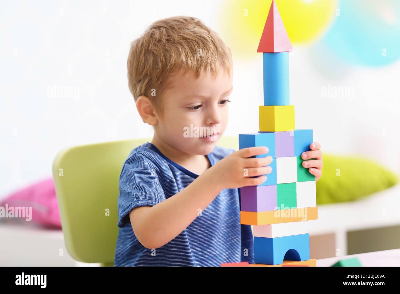 Cute little boy playing with colorful blocks at home Stock Photo - Alamy