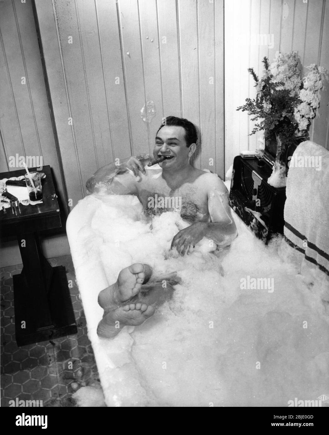 EDWARD G. ROBINSON on set candid smoking cigar in bubble bath during ...