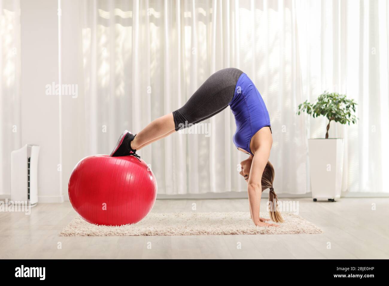 Woman balancing ball hi-res stock photography and images - Alamy