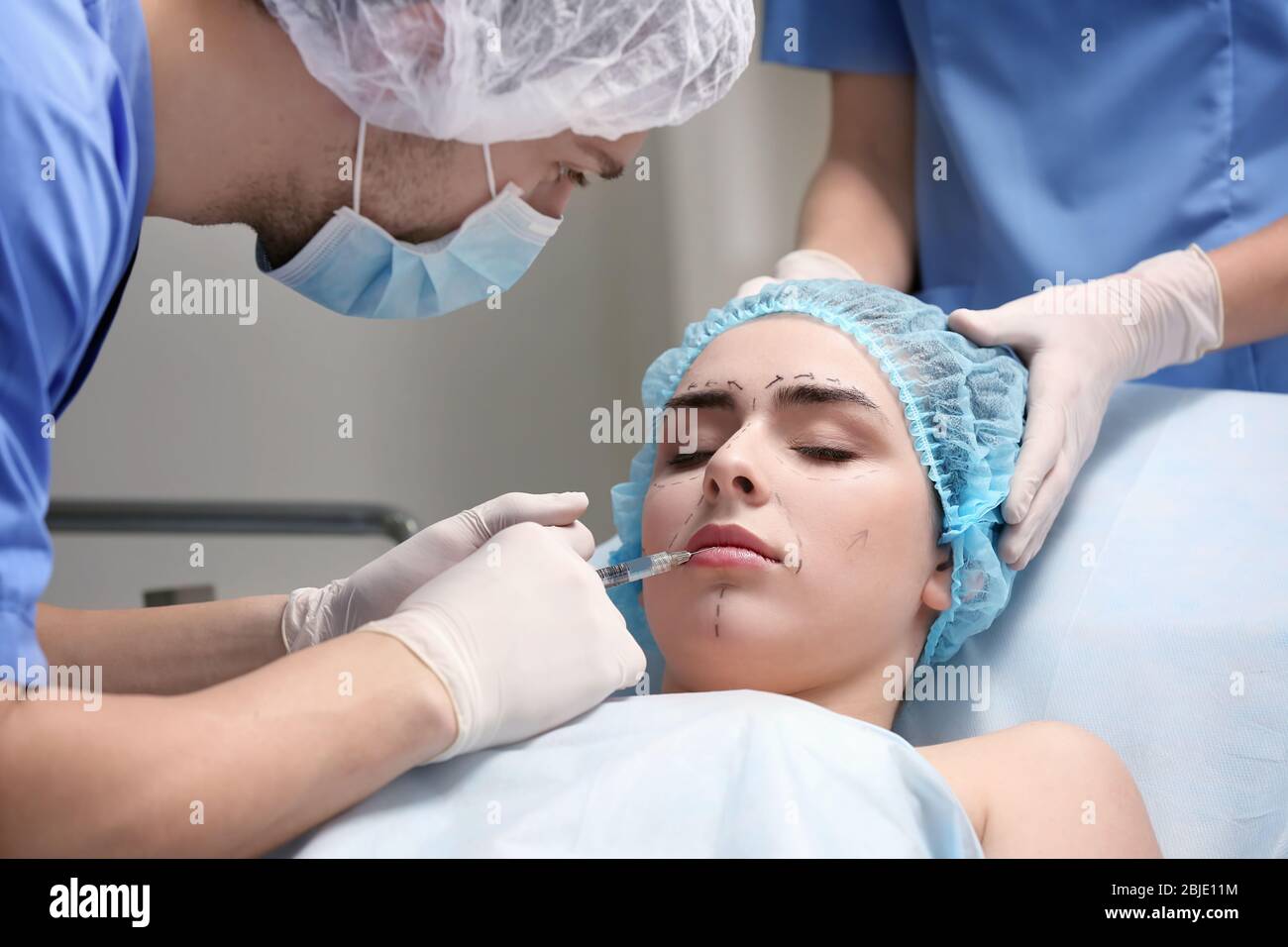 Plastic surgeon making facial injection in clinic Stock Photo - Alamy
