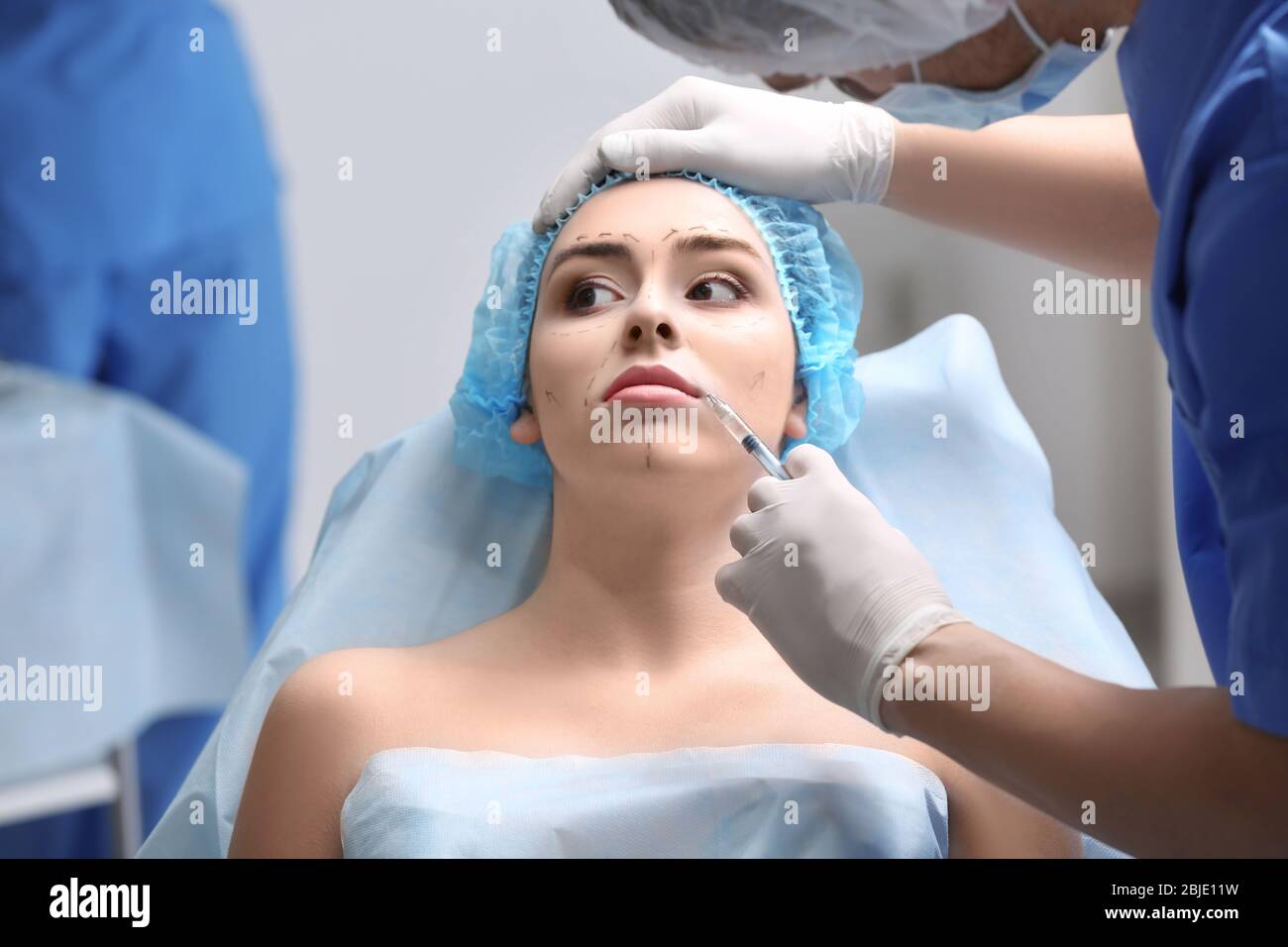 Plastic surgeon making facial injection in clinic Stock Photo - Alamy