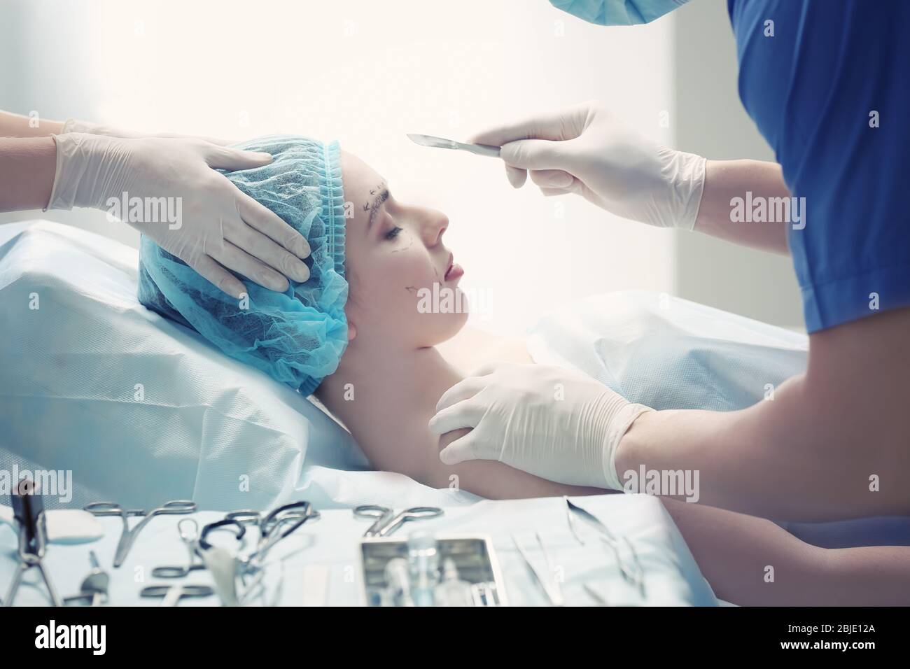 Plastic surgeon operating patient hi-res stock photography and images ...