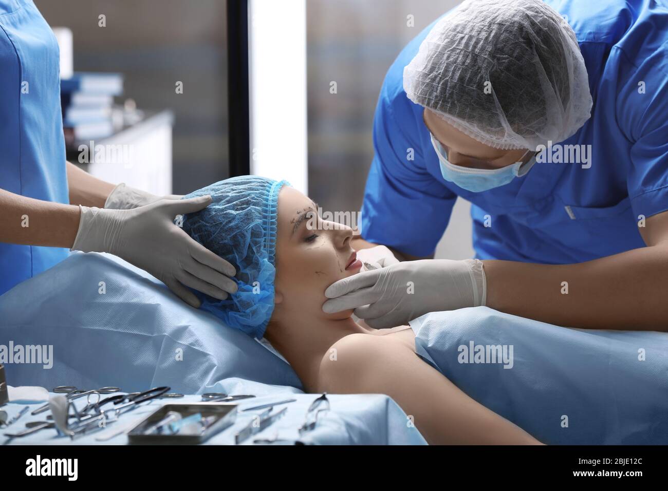 Plastic surgeon making facial injection in clinic Stock Photo - Alamy