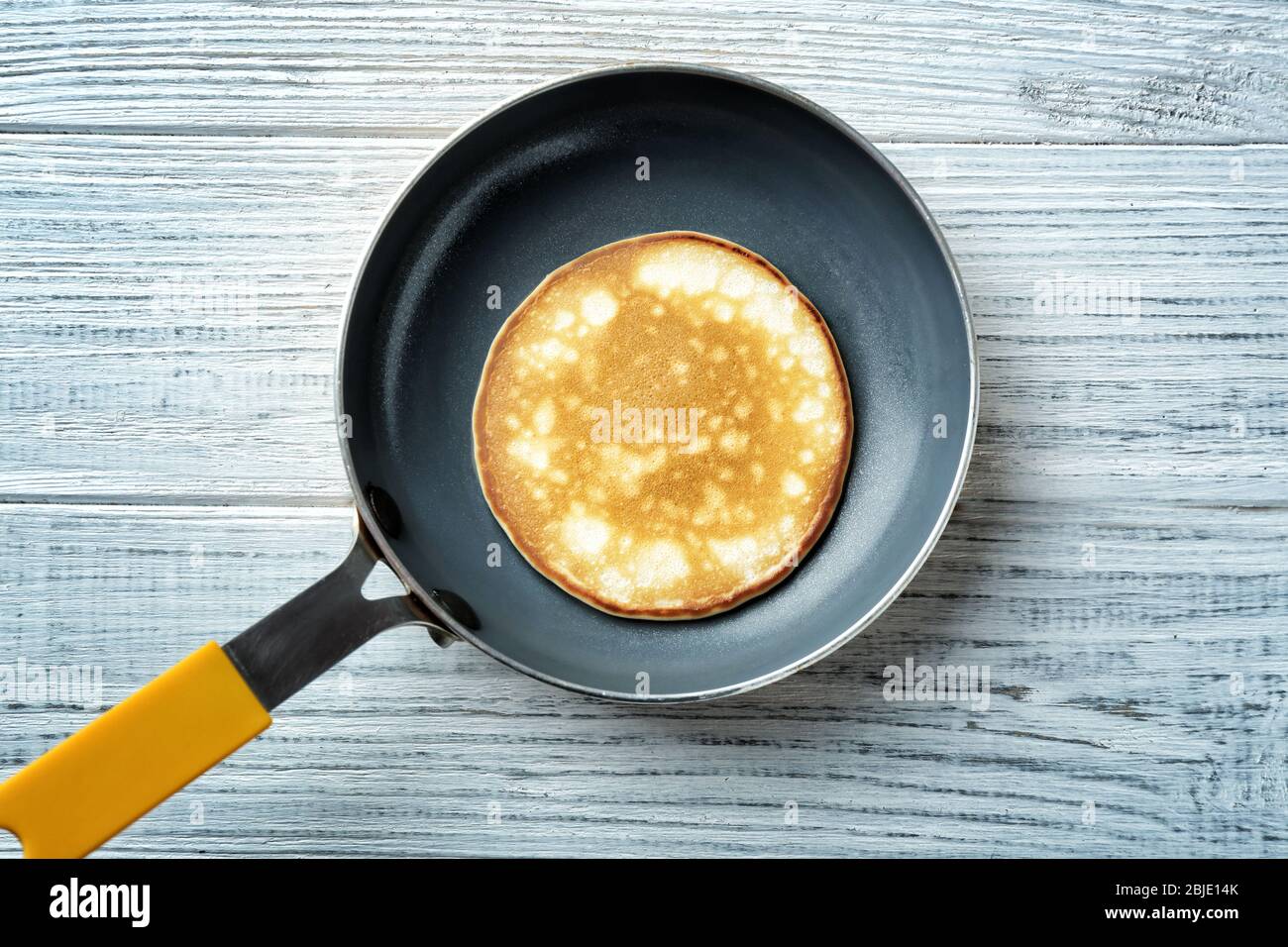 Preparation of pancakes on pan, top view Stock Photo - Alamy