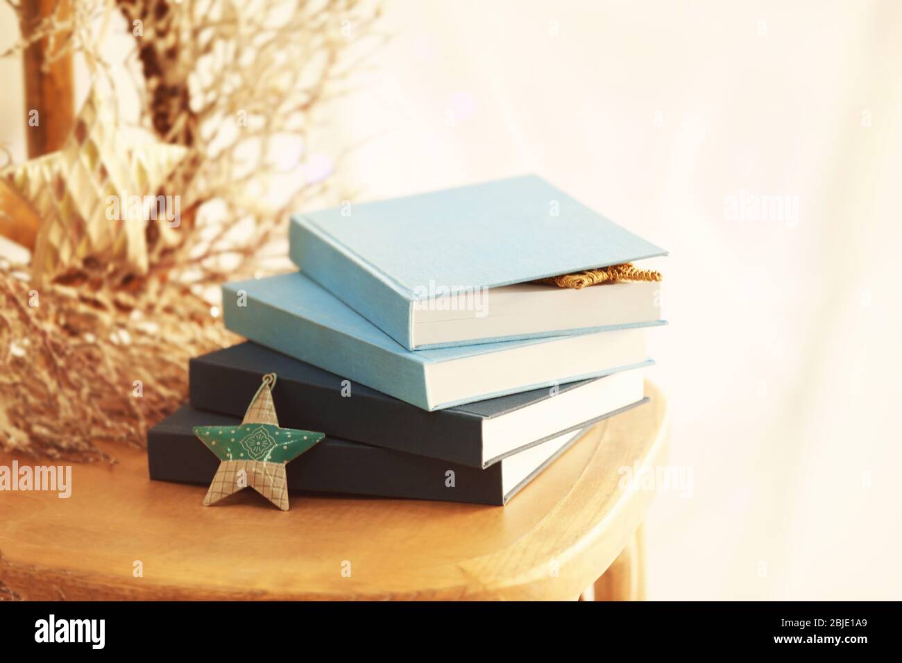Pile of books and decor on wooden chair, closeup Stock Photo - Alamy