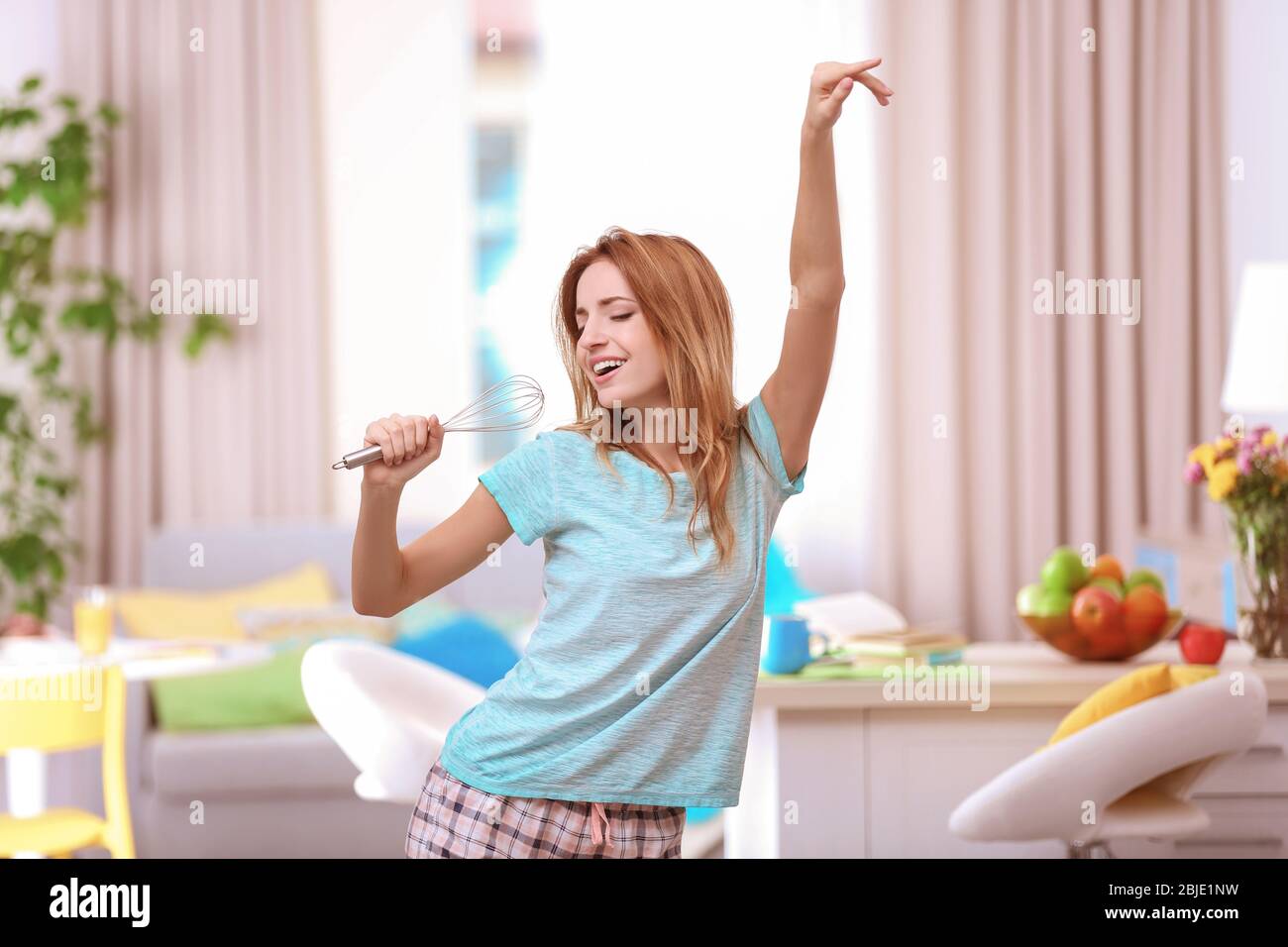 Beautiful young woman dancing at home Stock Photo - Alamy