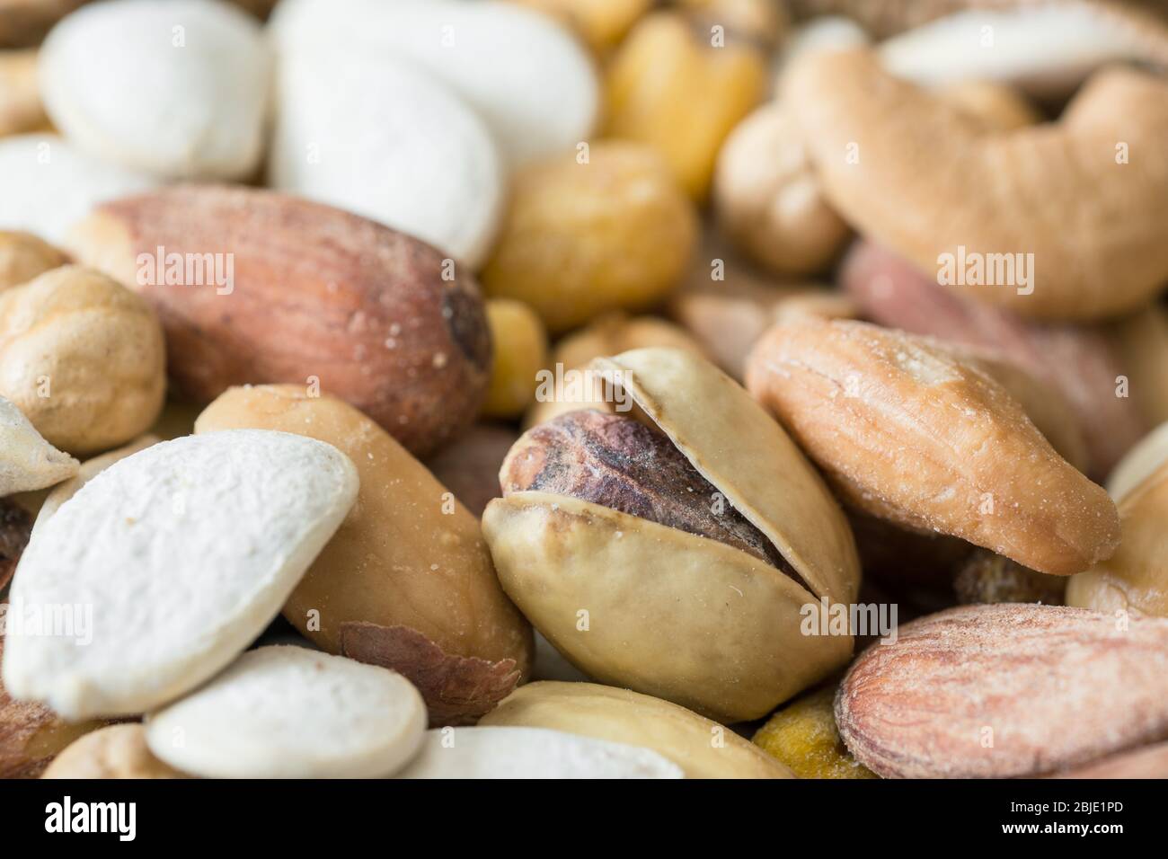 Roasted and salty, mixed nuts and kernels snack Stock Photo - Alamy