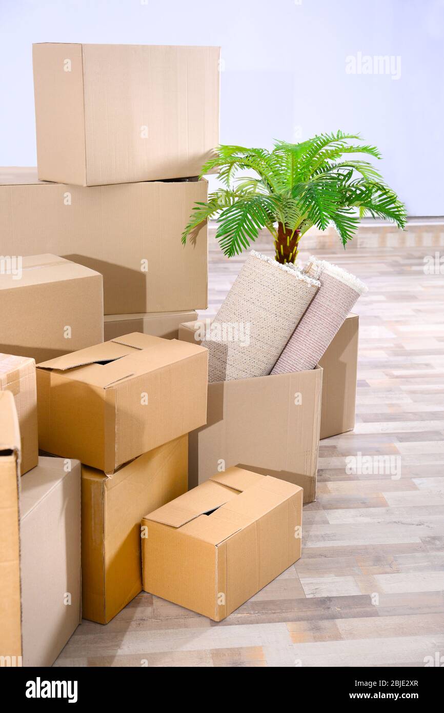 Pile of boxes for moving in office Stock Photo - Alamy