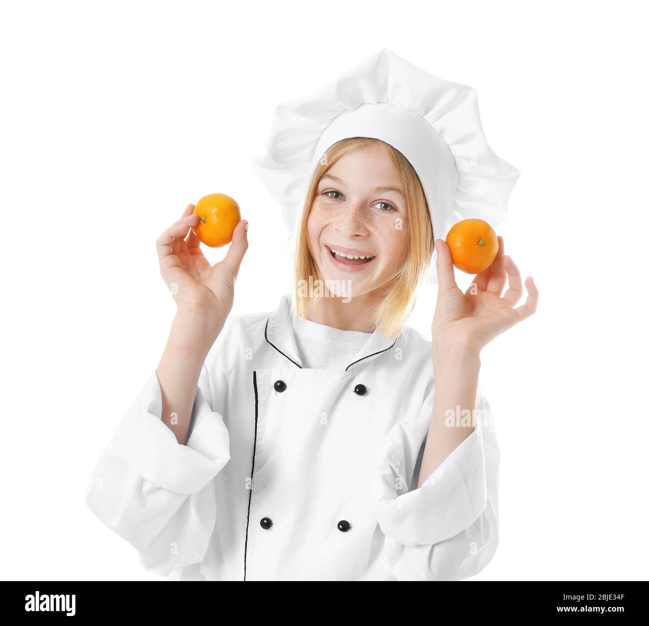 Cute girl in chef uniform on white background Stock Photo - Alamy