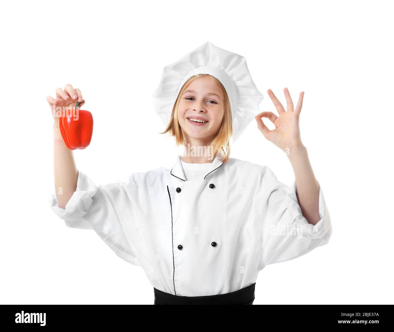 Cute girl in chef uniform on white background Stock Photo - Alamy