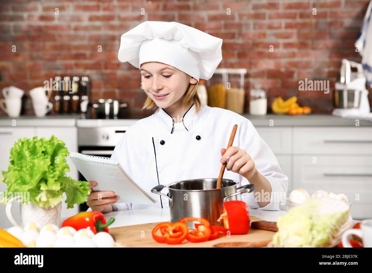 Cute girl cooking in kitchen at home Stock Photo - Alamy