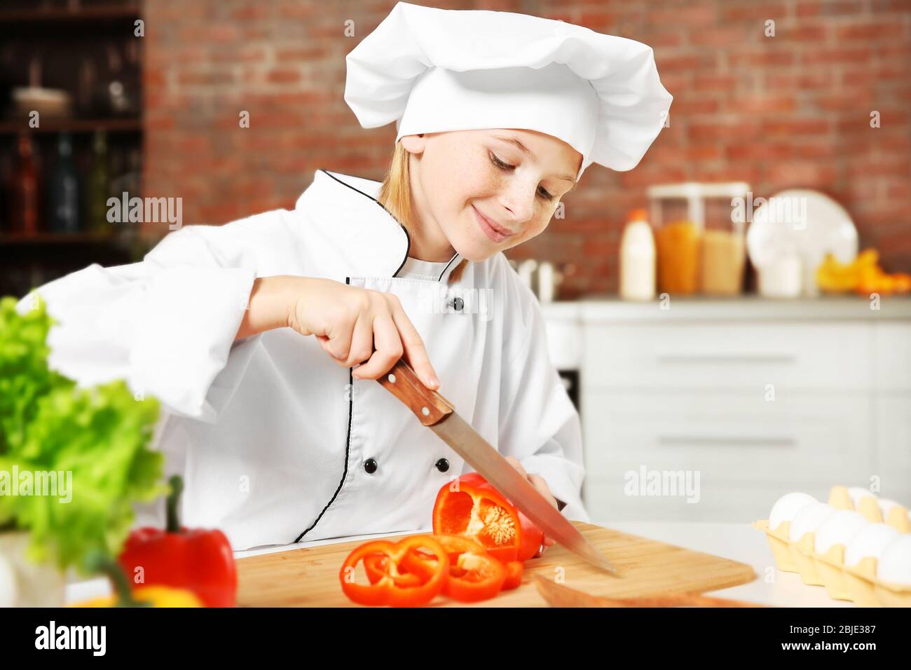 Cute girl cooking in kitchen at home Stock Photo - Alamy