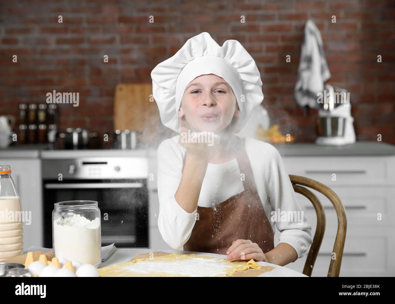 Cute girl cooking in kitchen at home Stock Photo - Alamy