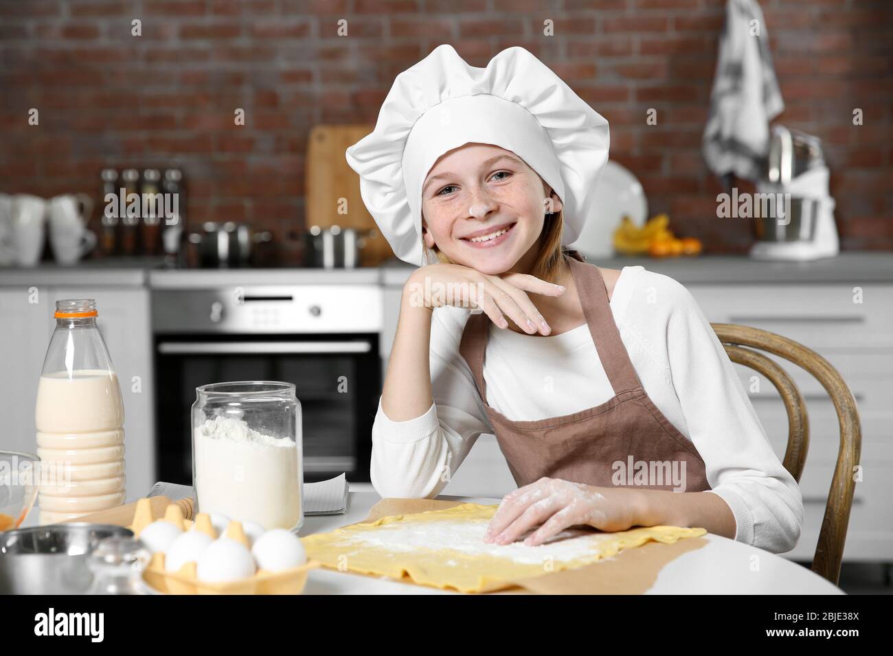 Cute girl cooking in kitchen at home Stock Photo - Alamy