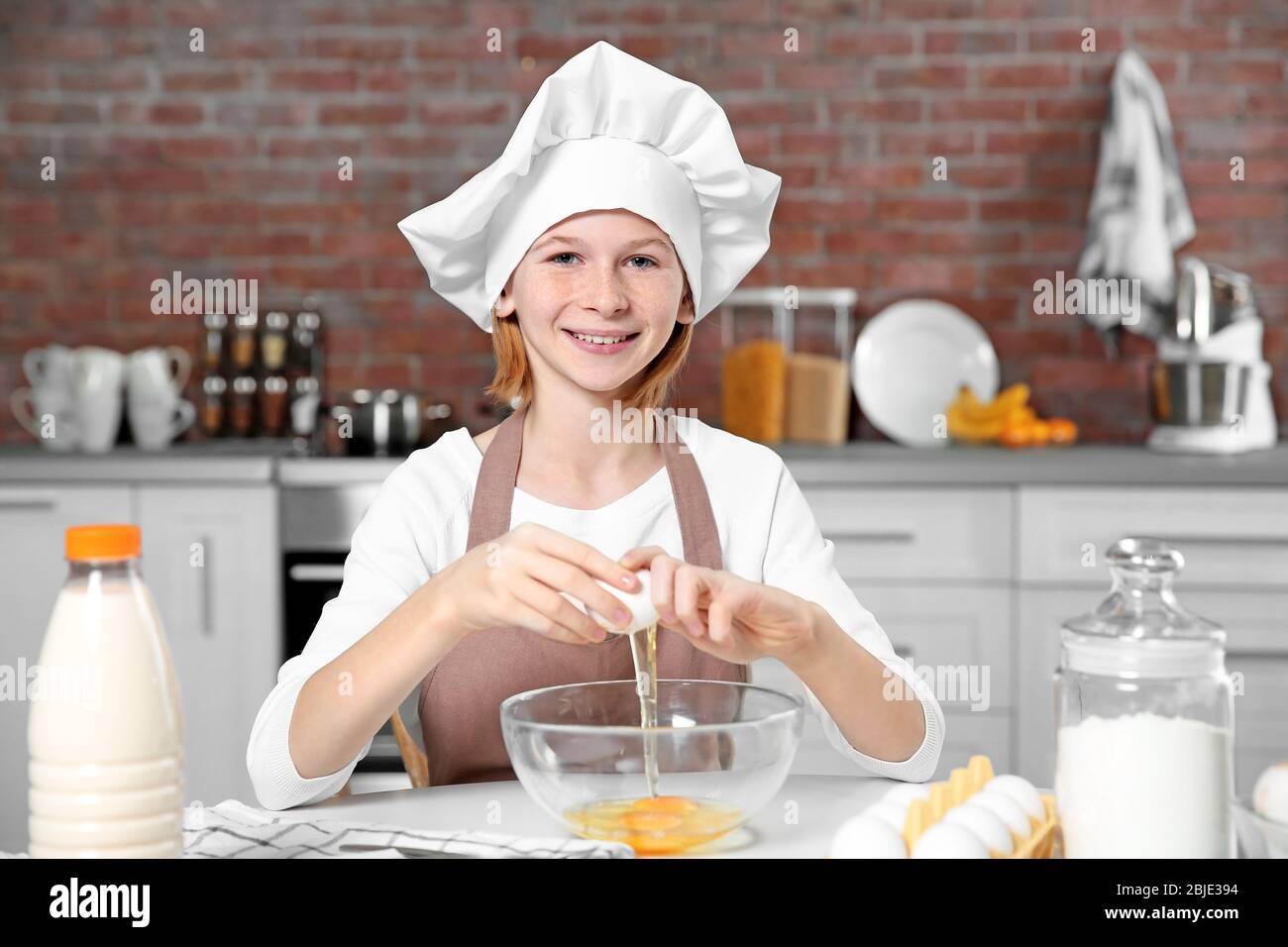 Cute girl cooking in kitchen at home Stock Photo - Alamy