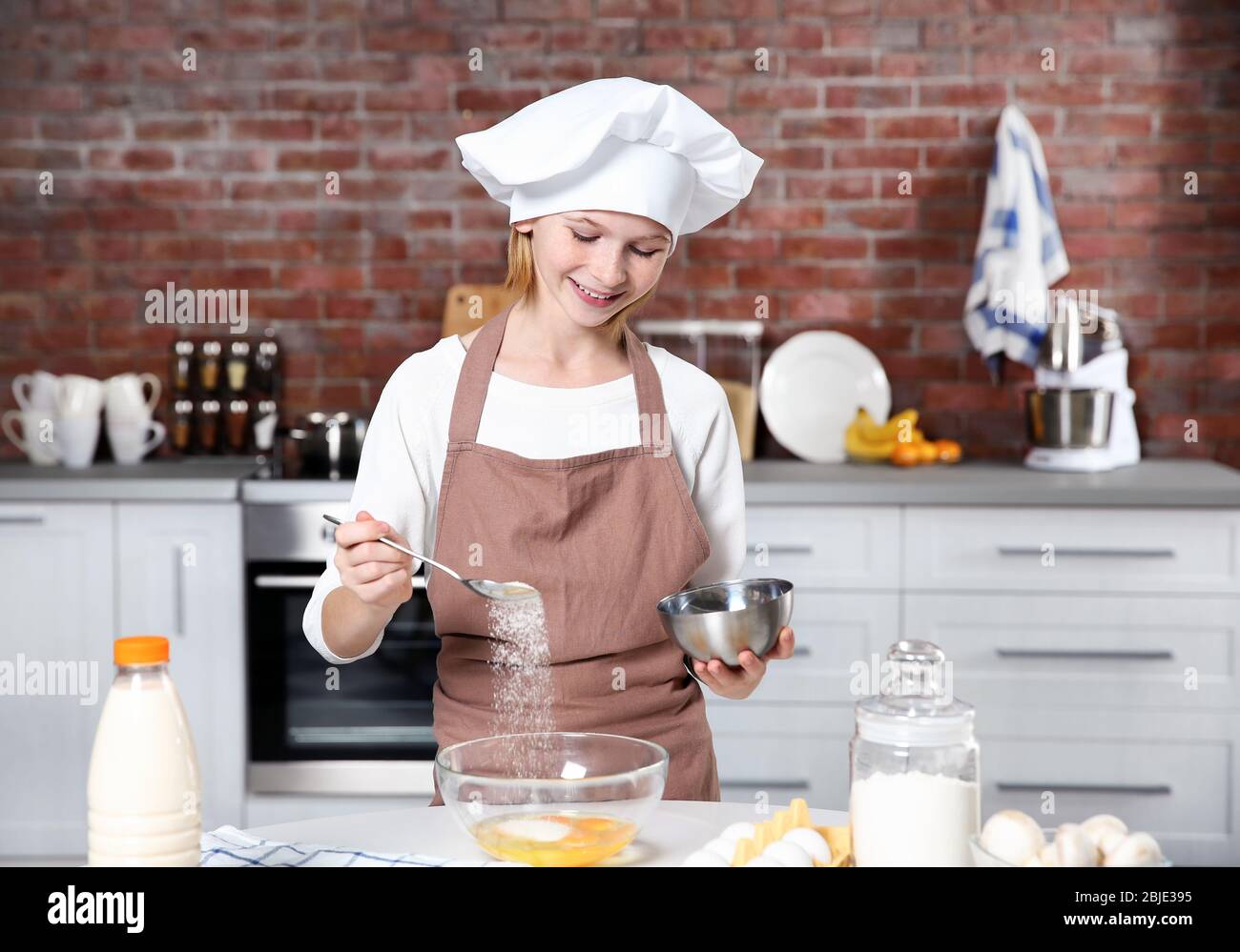 Cute girl cooking in kitchen at home Stock Photo - Alamy