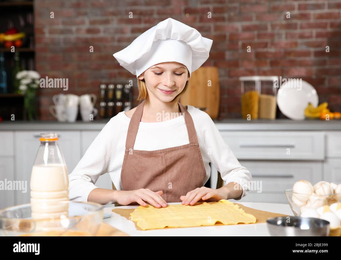 Cute girl cooking in kitchen at home Stock Photo - Alamy
