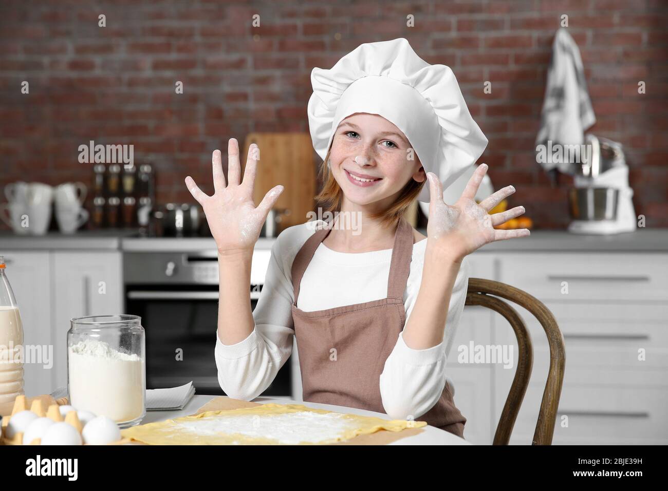 Cute girl cooking in kitchen at home Stock Photo - Alamy