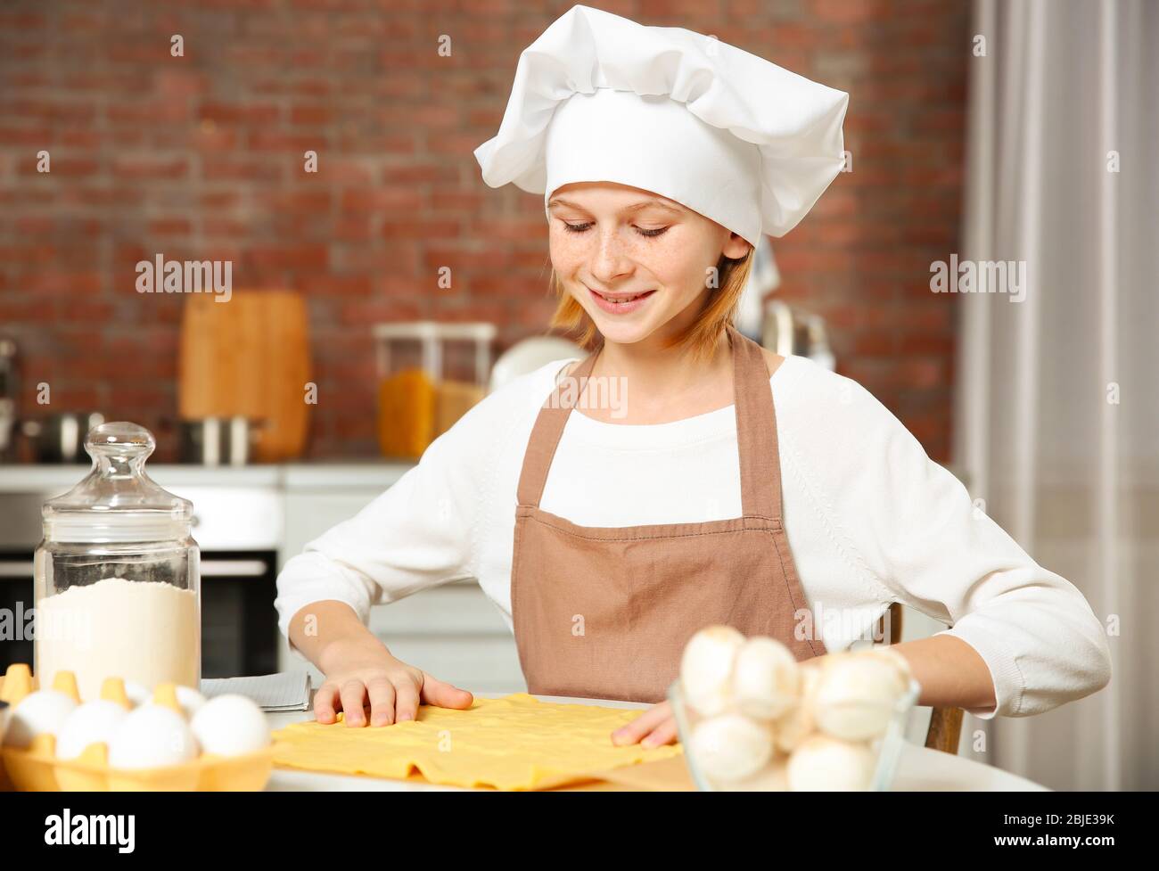Cute girl cooking in kitchen at home Stock Photo - Alamy