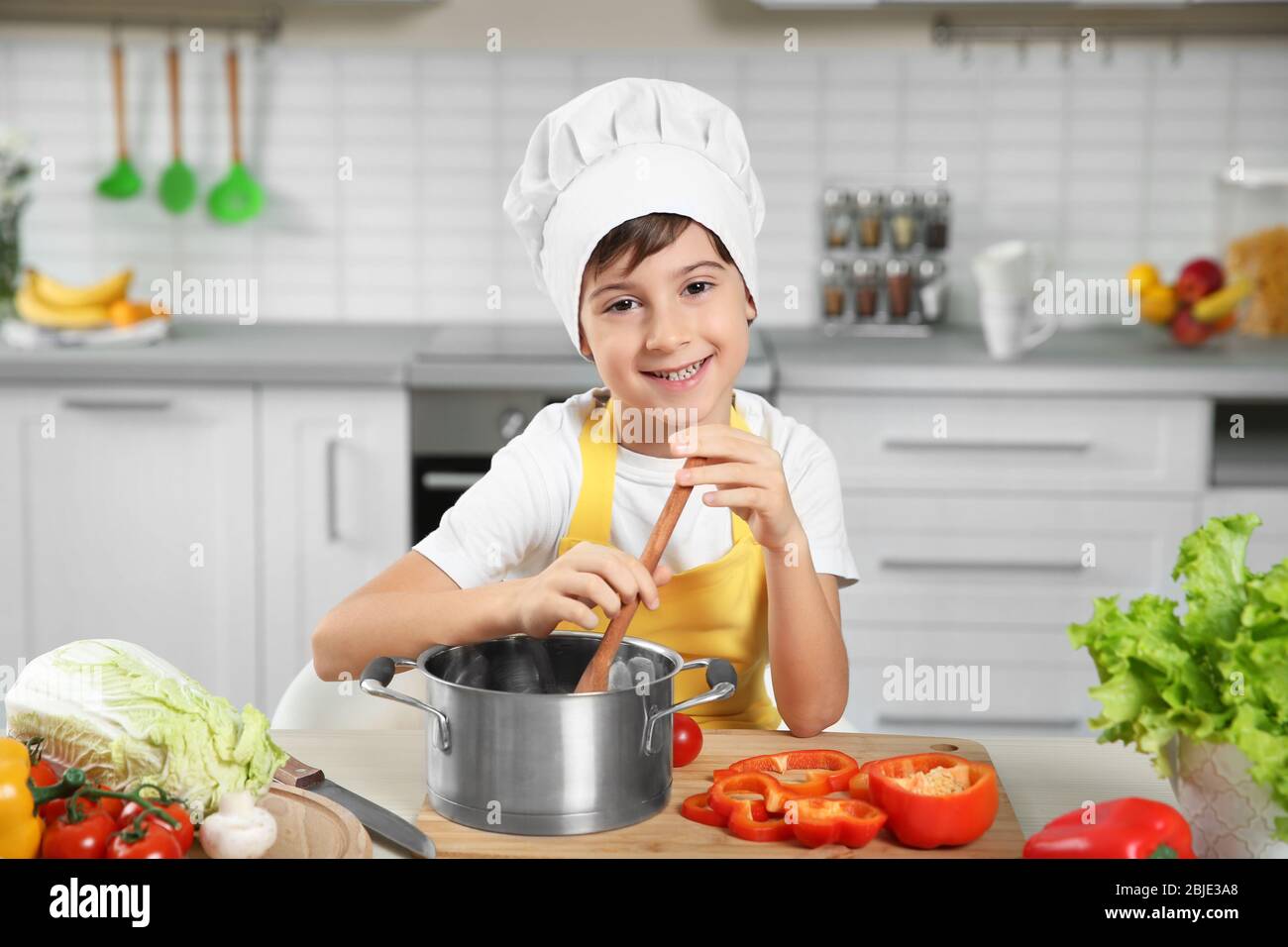 Cute boy cooking in kitchen at home Stock Photo - Alamy