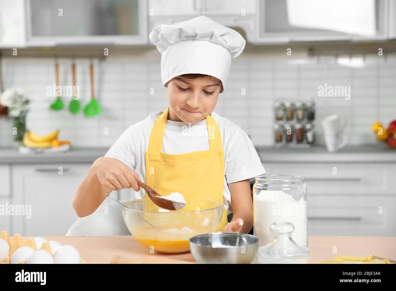 Cute boy cooking in kitchen at home Stock Photo - Alamy