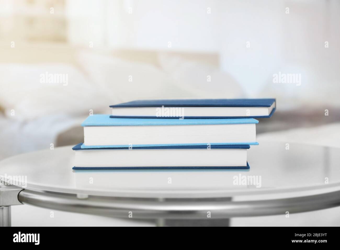 Pile of books on table Stock Photo - Alamy