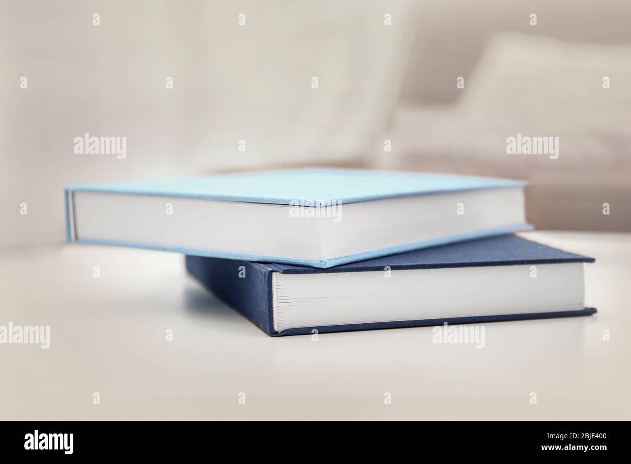 Pile of books on white table, closeup Stock Photo - Alamy