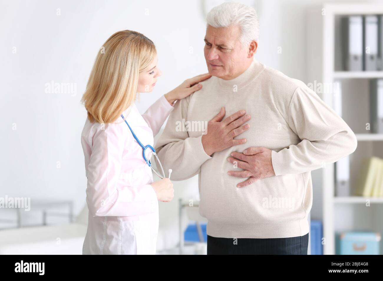 Aged patient complaining to doctor at hospital Stock Photo - Alamy