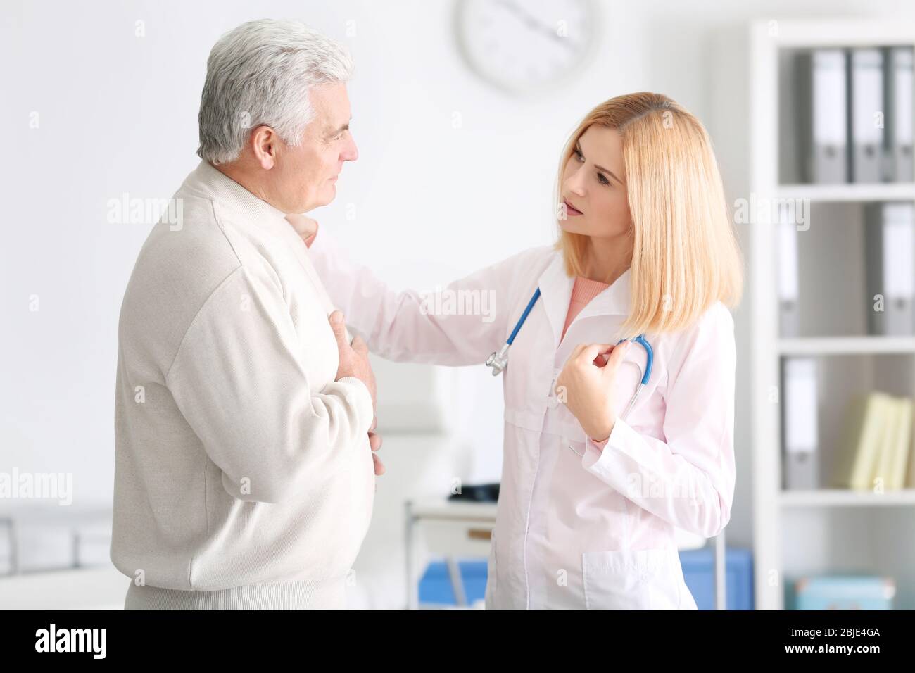Aged patient complaining to doctor at hospital Stock Photo - Alamy