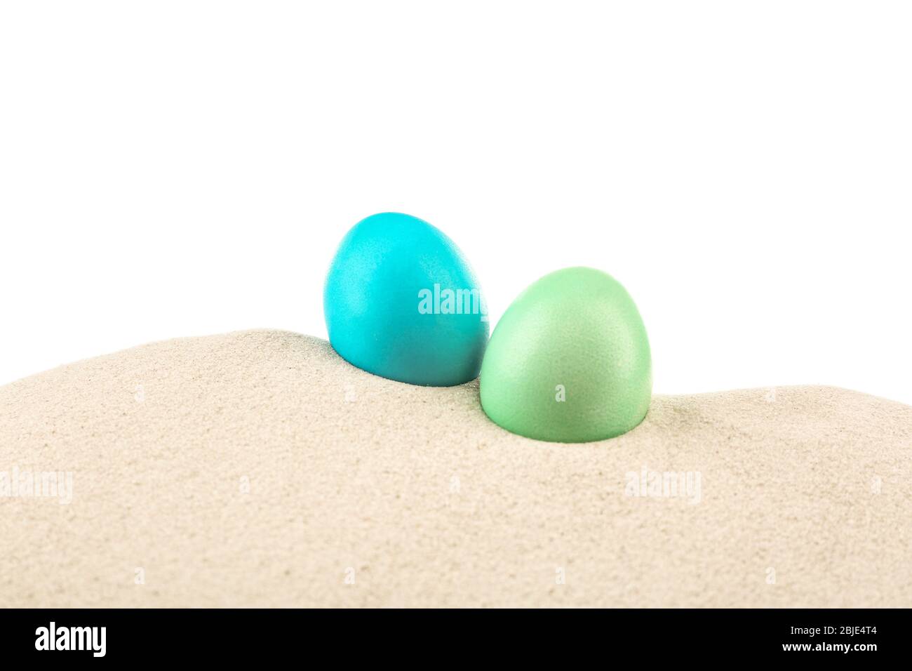 Easter eggs with sand, on white background Stock Photo - Alamy