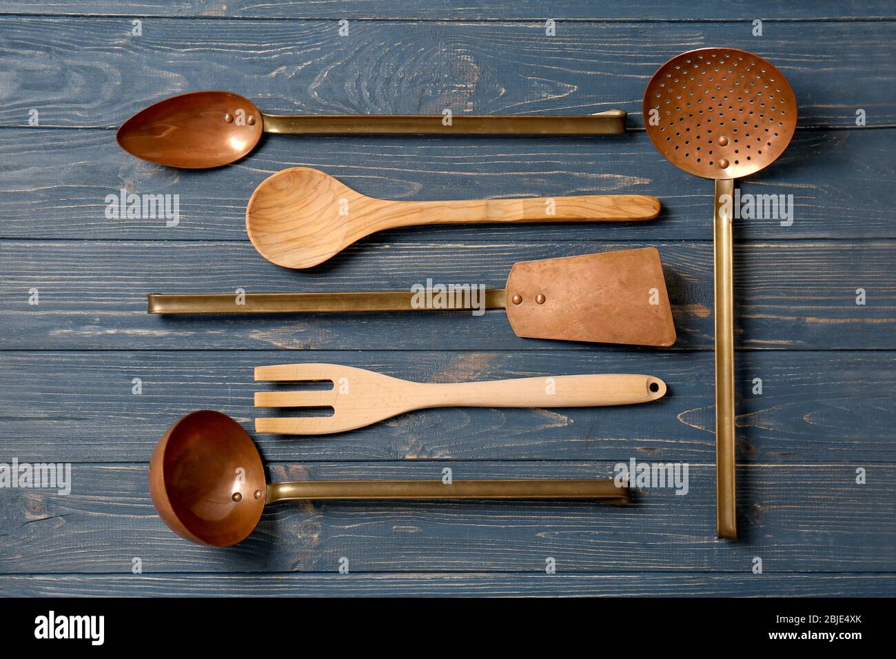 Kitchen utensils on wooden background Stock Photo - Alamy