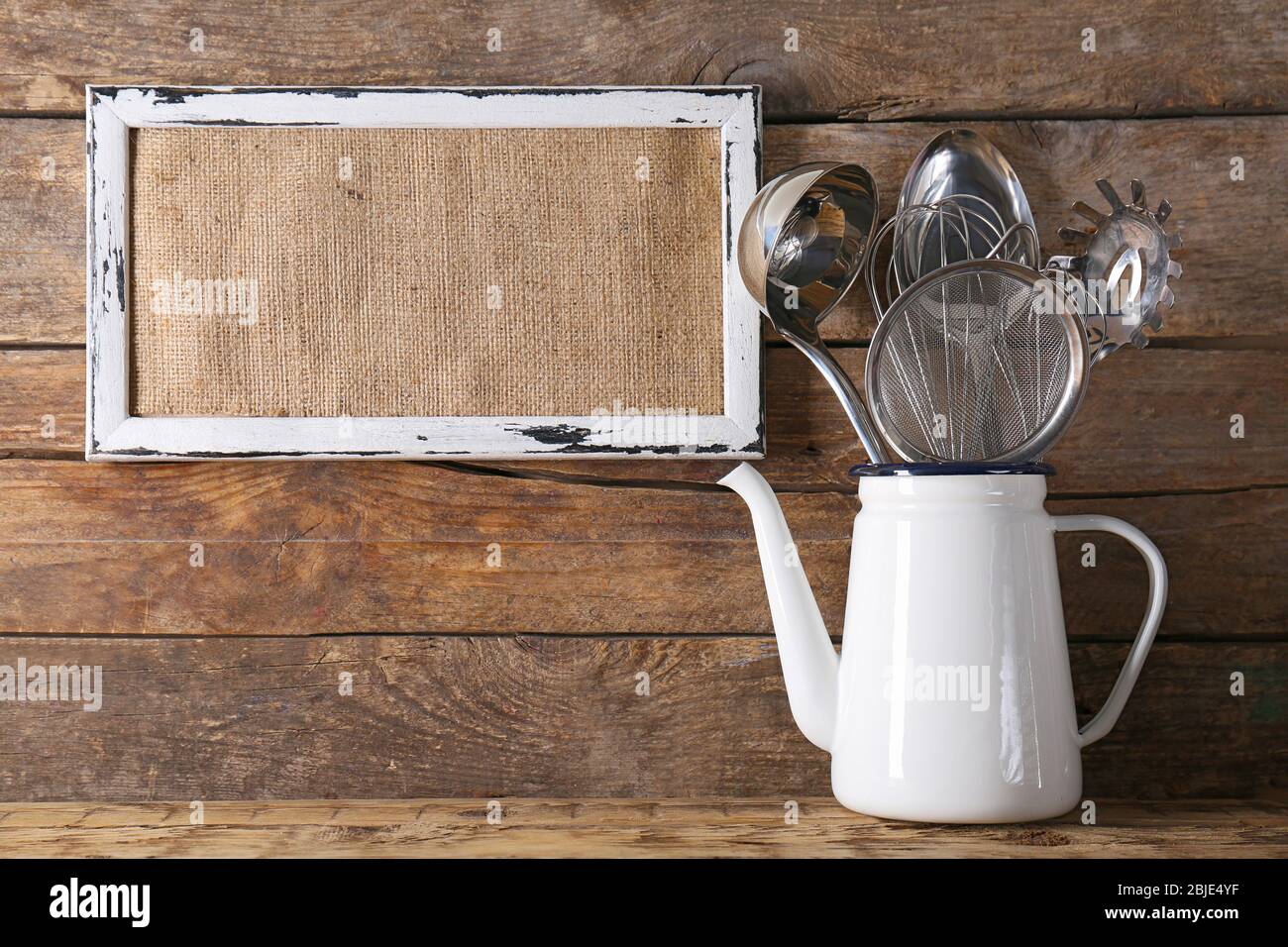 Kitchen utensils and blank frame on wooden background Stock Photo - Alamy