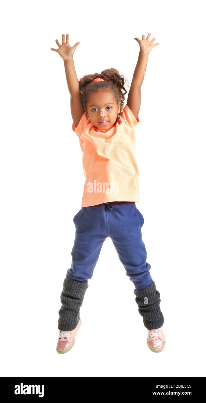 Cute African American girl jumping on white background Stock Photo - Alamy