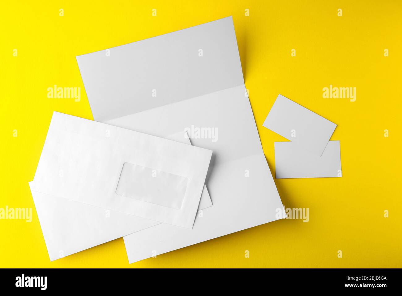 Blank brochure, envelope and card on yellow background Stock Photo - Alamy