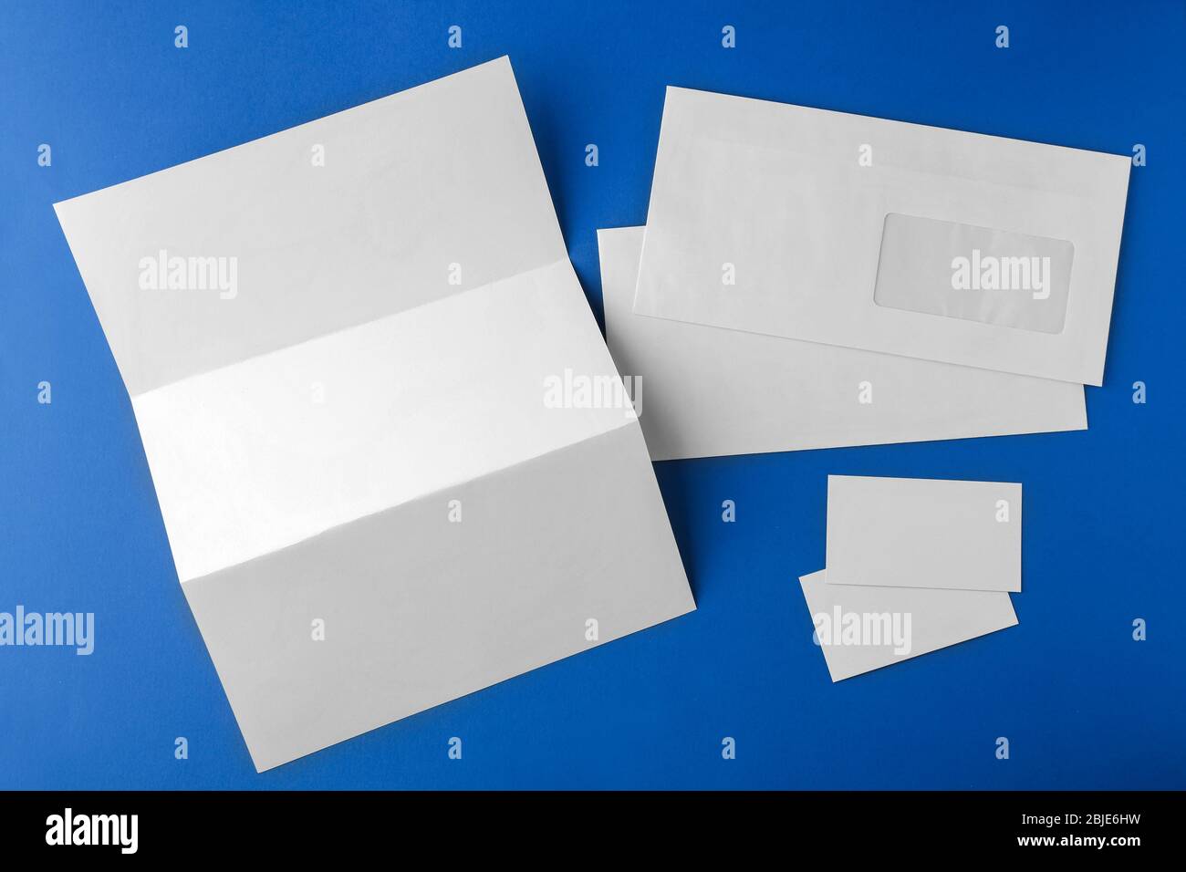 Blank brochure, envelope and card on blue background Stock Photo - Alamy