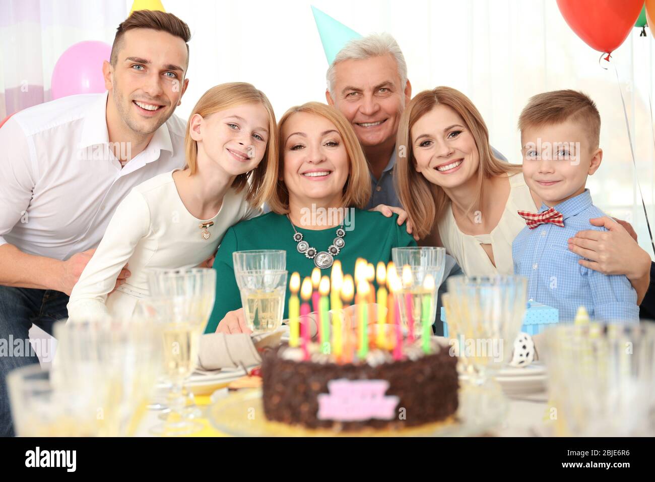 Family celebrating birthday with cake Stock Photo - Alamy