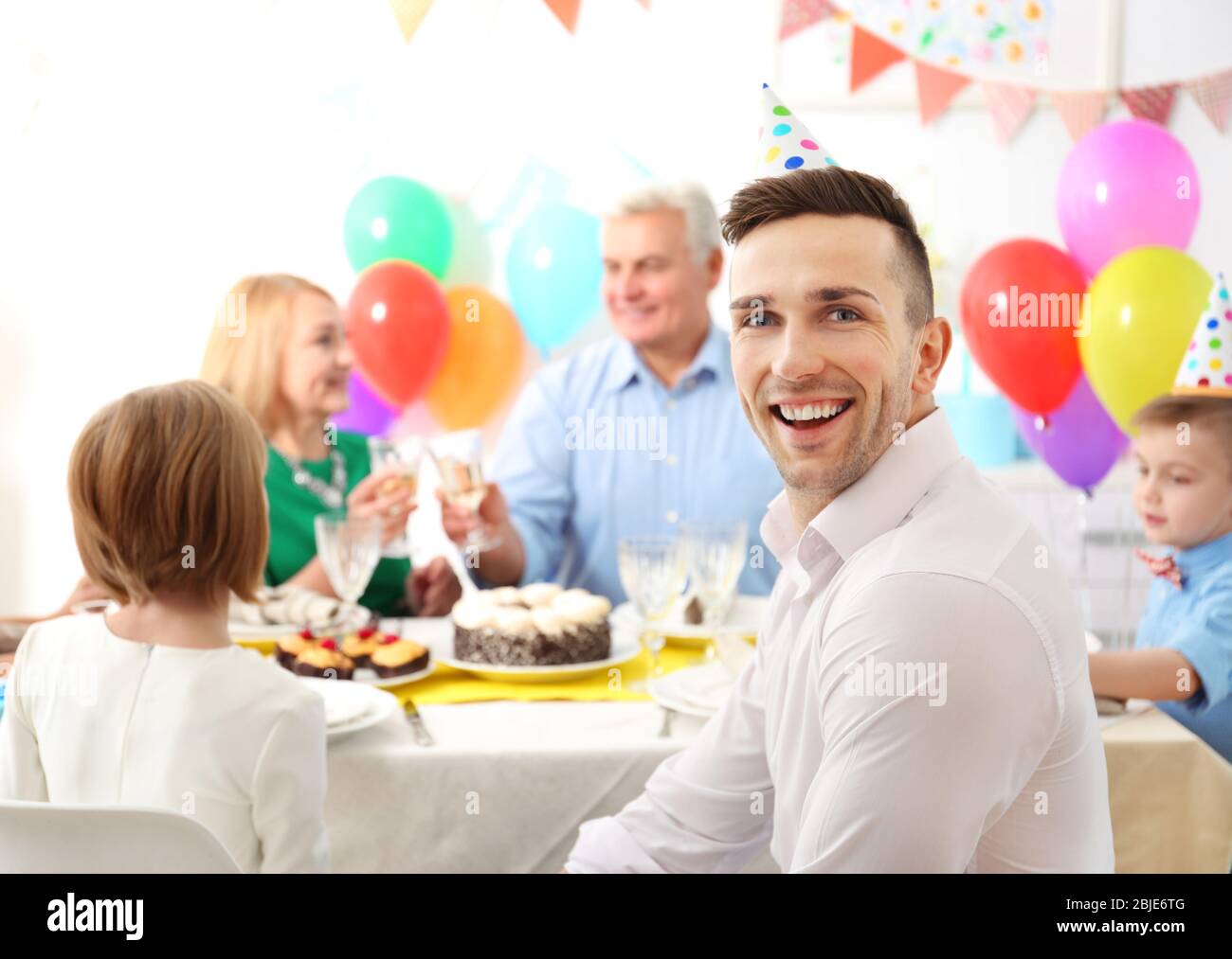 Family celebrating birthday at home Stock Photo - Alamy