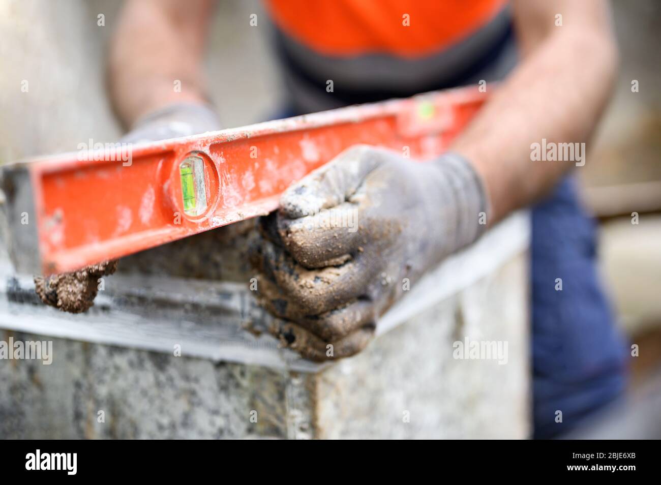 Construction worker checking the bubble level while working at ...