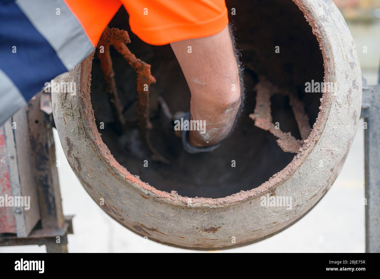 Construction Site, Unrecognizable Worker cleaning Concrete Mixer Stock ...