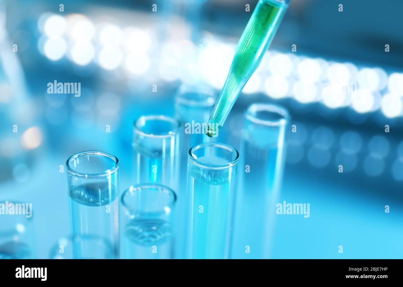 Pipette dropping a sample into a test tube, closeup Stock Photo - Alamy