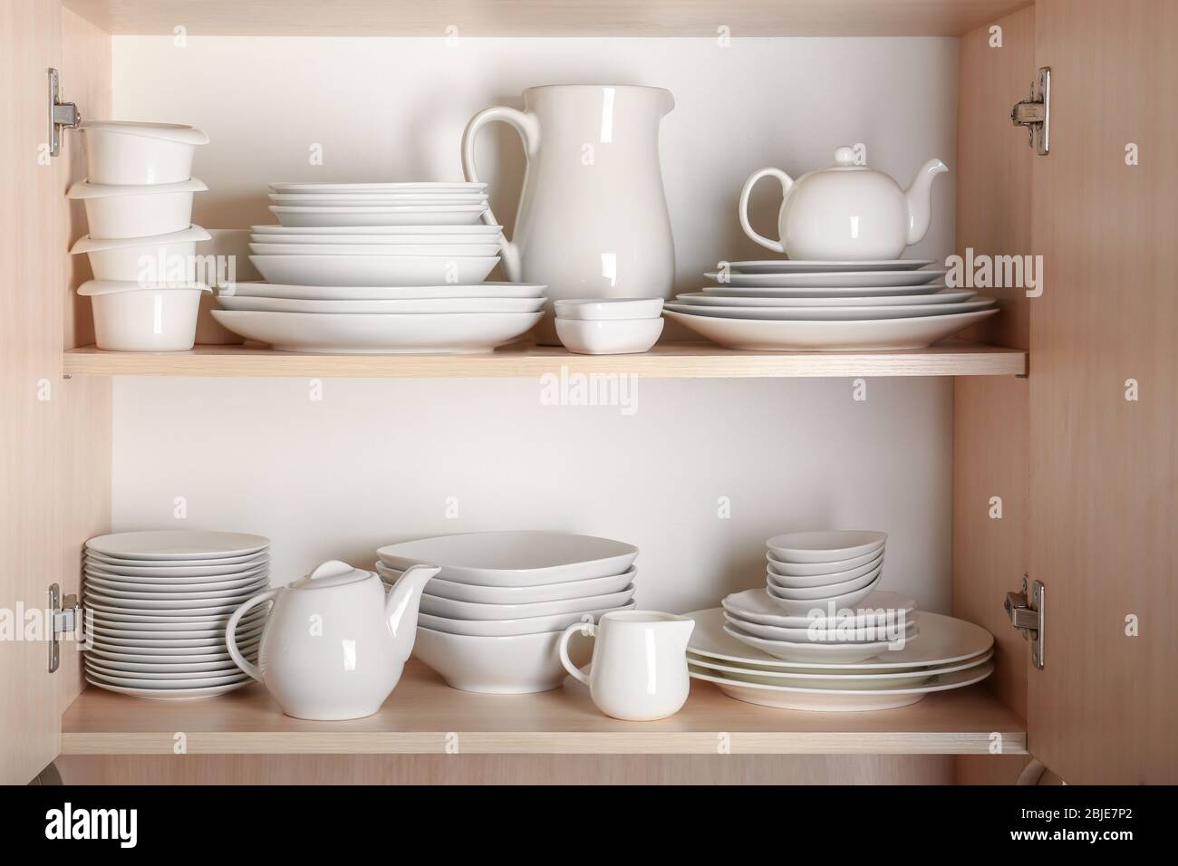 Kitchen cupboard with nice rustic dinnerware Stock Photo - Alamy