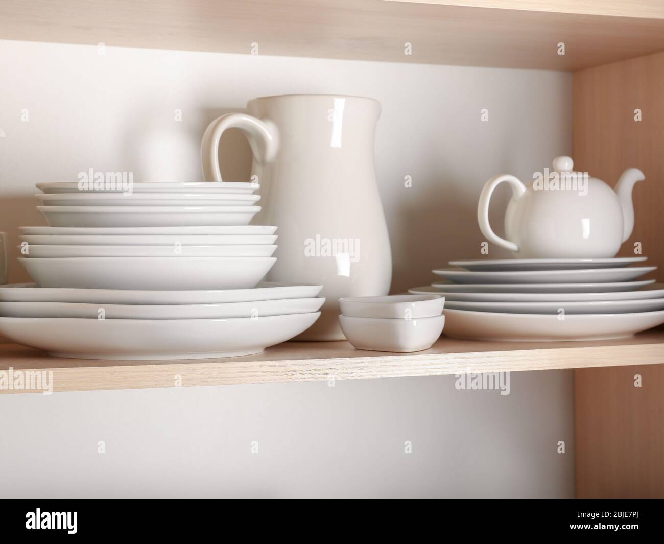 Kitchen cupboard with nice rustic dinnerware Stock Photo - Alamy