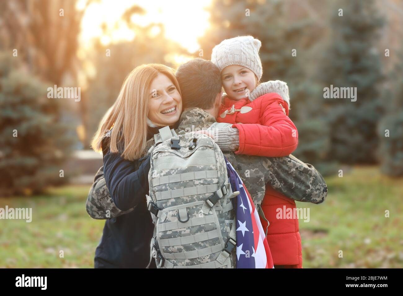 USA soldier hugging his family outdoors Stock Photo - Alamy