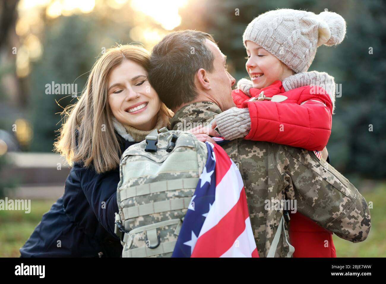 USA soldier hugging his family outdoors Stock Photo - Alamy
