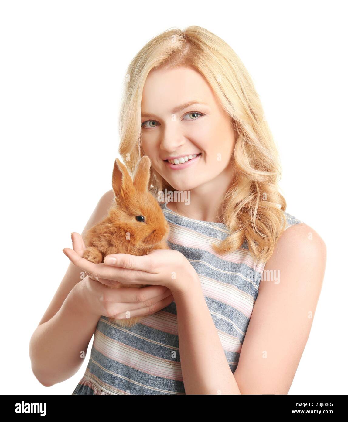Beautiful girl holding small rabbit on white background Stock Photo - Alamy