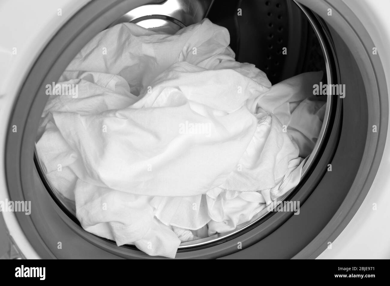 Washing machine and clothes, close up Stock Photo - Alamy